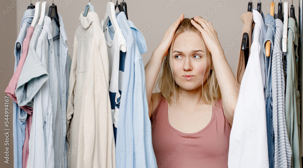 Depression a woman holds her head with her hands, standing near a ...