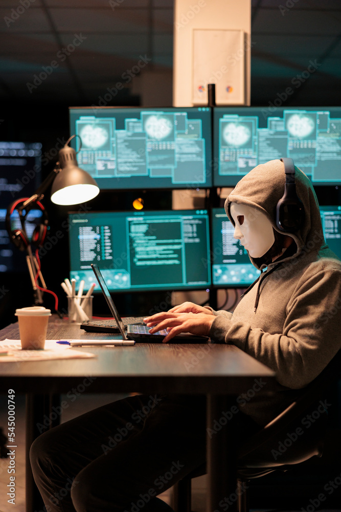 Dangerous masked hacker stealing information from database server online, hacking computer ...