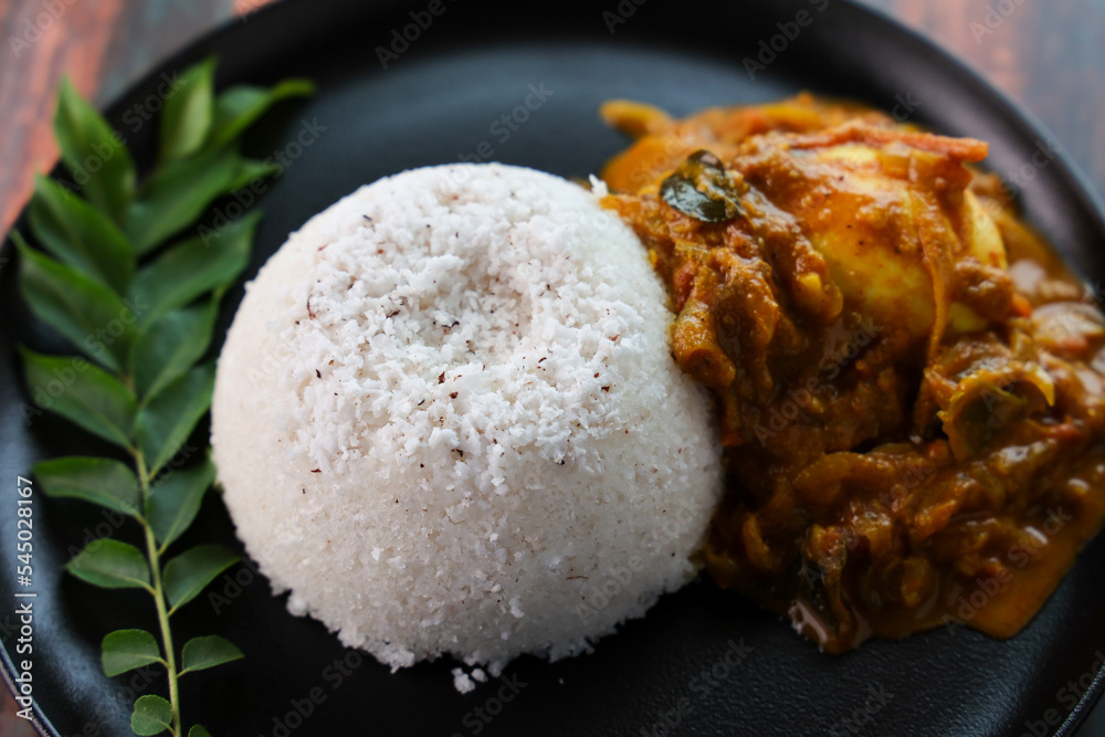 Rice Puttu or pittu steamed rice cake and egg roast curry popular in ...