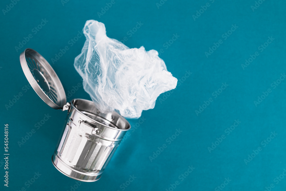 recycling and avoiding landfill, open trash can with single use plastic ...