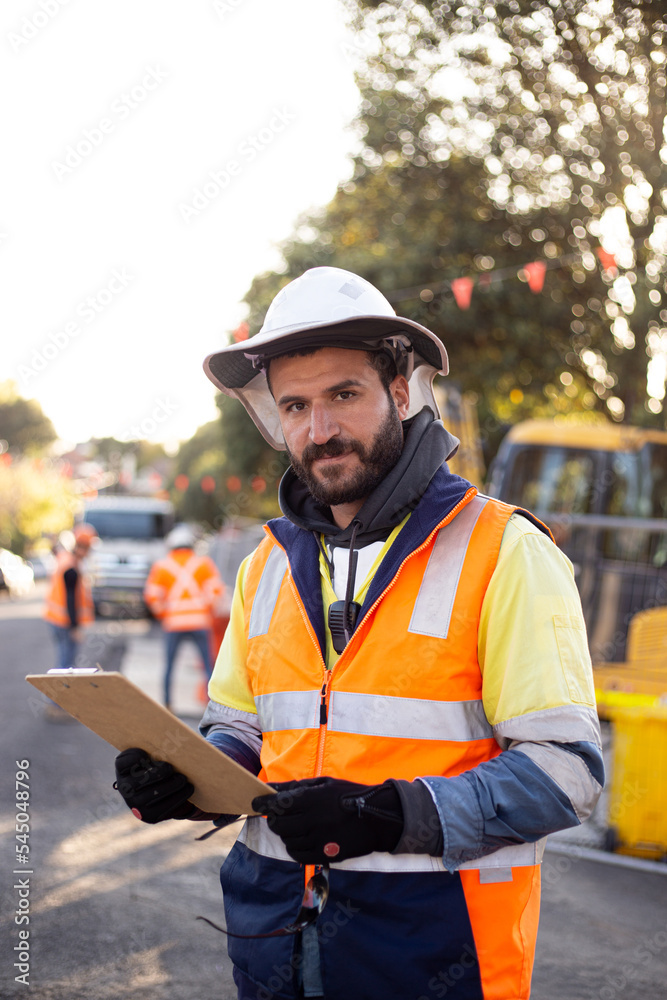 Man road worker with beard wearing white hat with yellow and orange ...