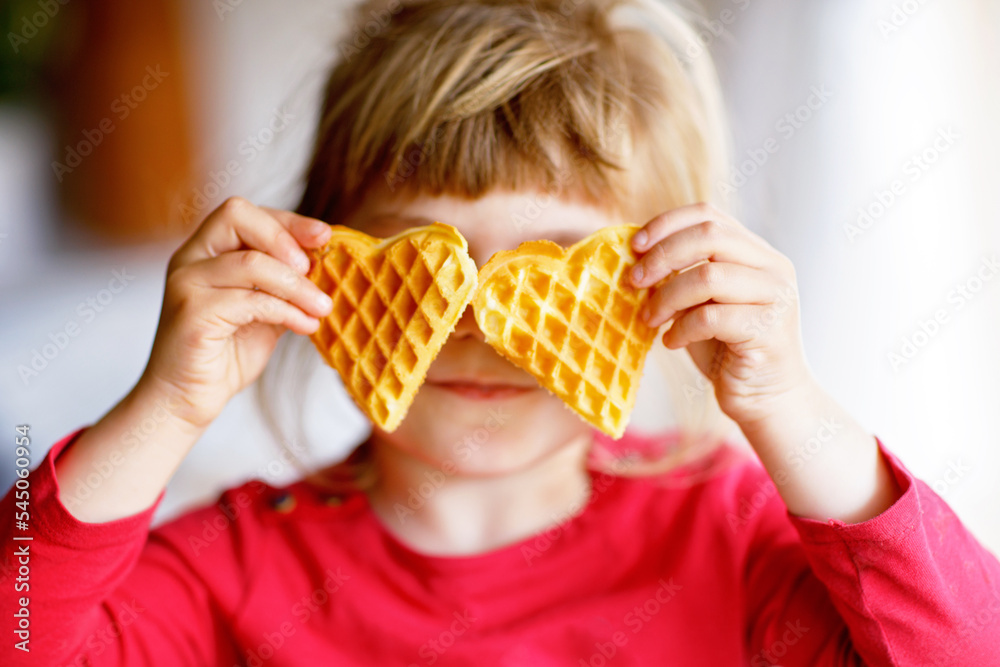 Portrait of happy little preschool girl holding fresh baked heart ...