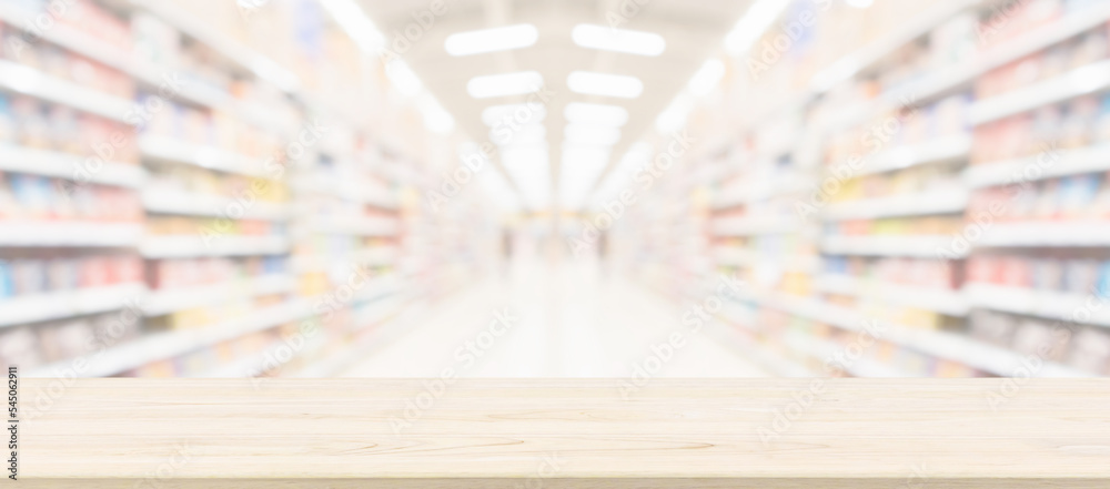 Wood table top with supermarket grocery store blurred background with ...