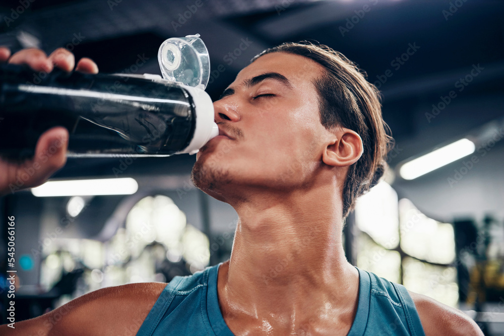 Man, drinking water and training exercise in sports gym for healthy ...