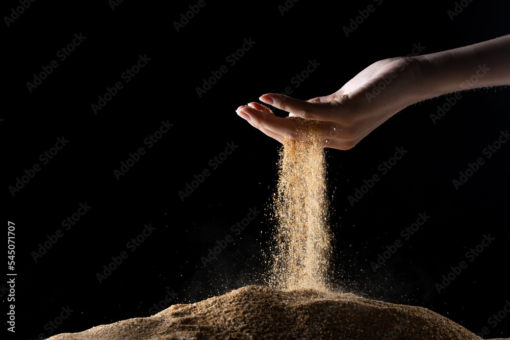 Hand releasing dropping sand. Fine Sand flowing pouring through fingers ...
