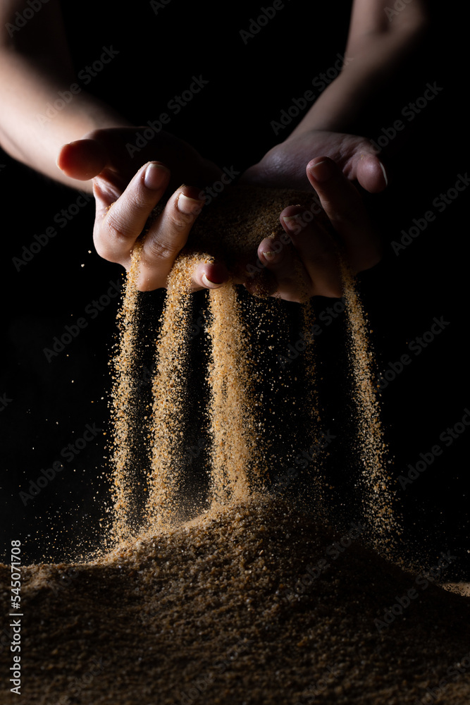 Hand releasing dropping sand. Fine Sand flowing pouring through fingers ...