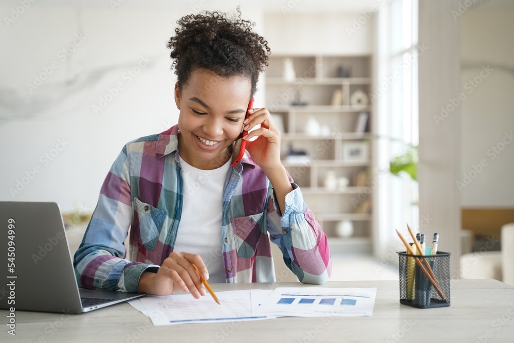 Smiling mixed race school girl student makes phone call, learning at ...