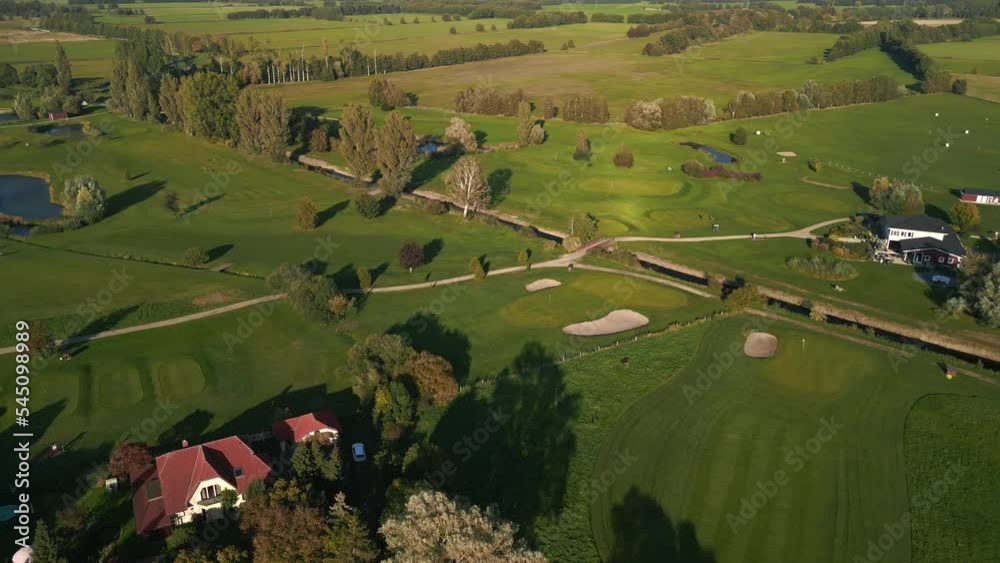Fantastic aerial view flight of golf course in the forest woods ...