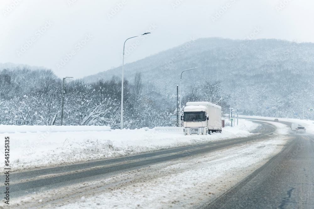 Big commercial semi-trailer truck trapped in snow drift on closed ...