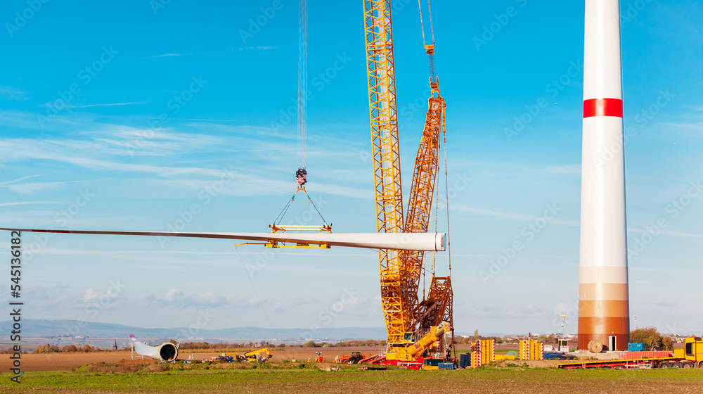 Construction Work Of Wind Turbine Crane Is Holding Grabing A Blade Of A Wind Turbine Building