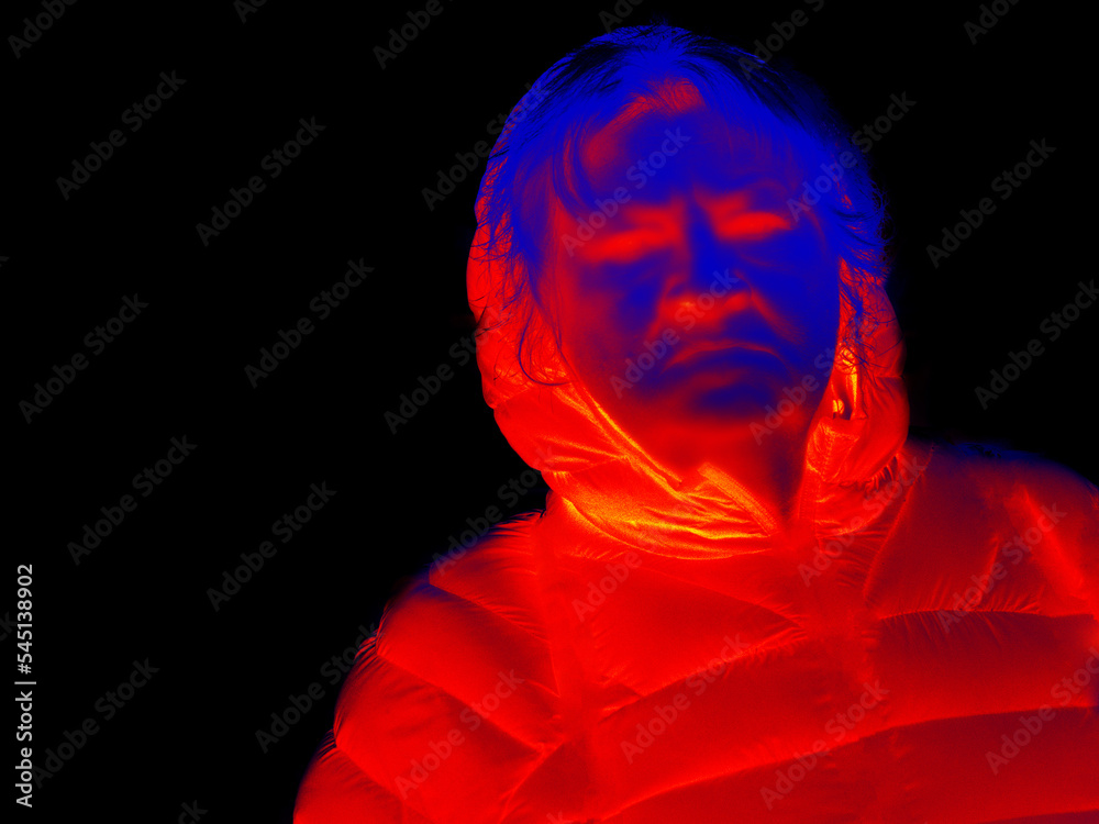 Red portrait of an old woman. Blurred unrecognizable people ...