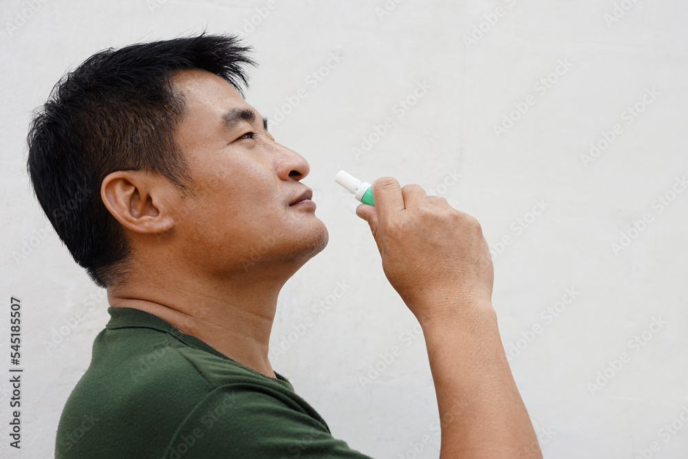 Foto de Asian man uses inhaler to smell for relieve dizzy and faint ...
