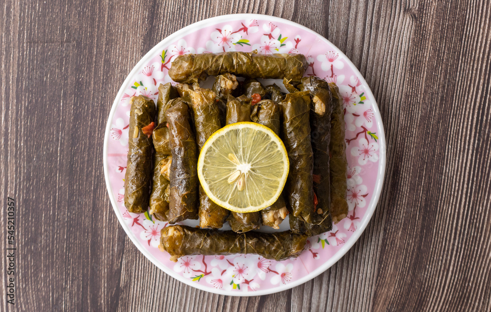 Delicious dolma (sarma) stuffed grape leaves rice, white yogurt sauce ...