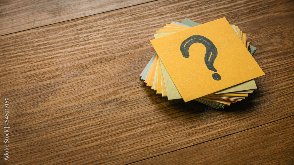 Foto de Questions and answers concept. A stack of paper with a paper on ...
