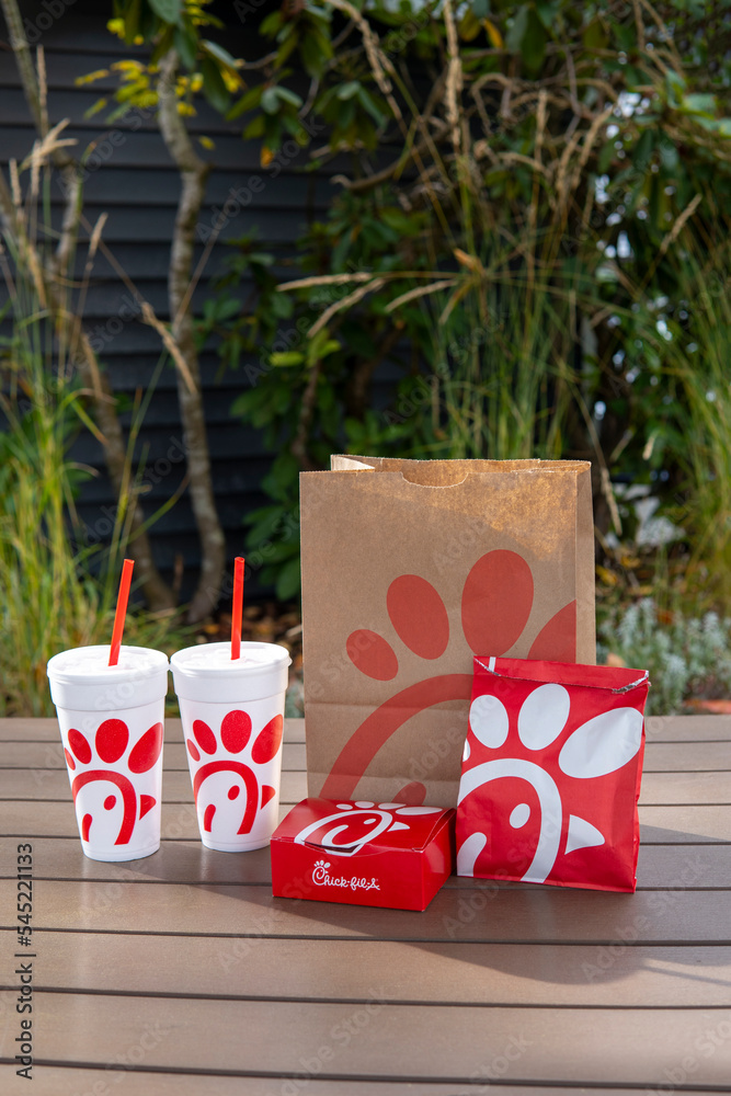 Chick-fil-a food on the table on the green bush background. Chick fil a ...
