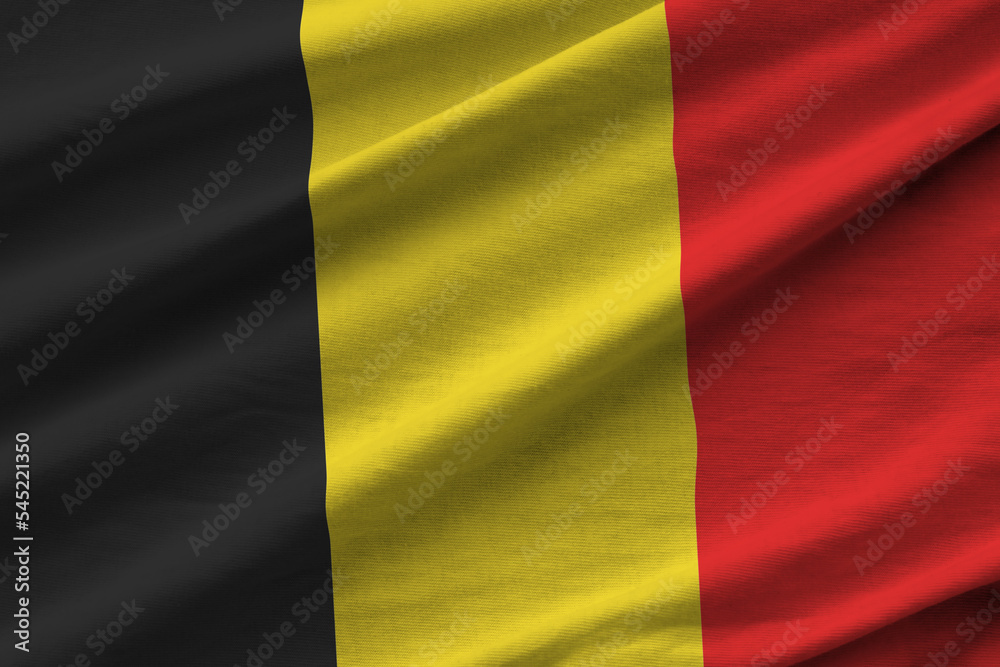 Belgium flag with big folds waving close up under the studio light ...