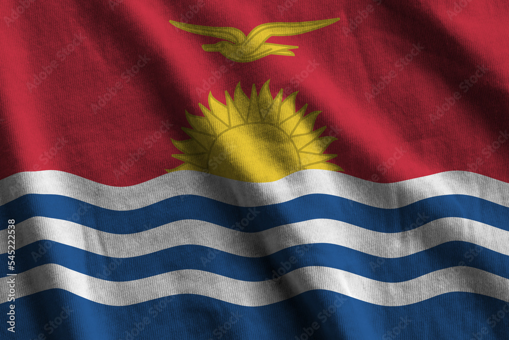 Kiribati flag with big folds waving close up under the studio light ...