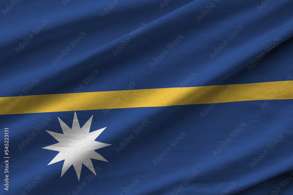 Nauru flag with big folds waving close up under the studio light ...