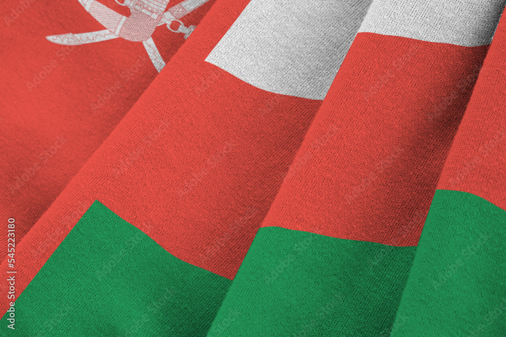 Oman flag with big folds waving close up under the studio light indoors ...
