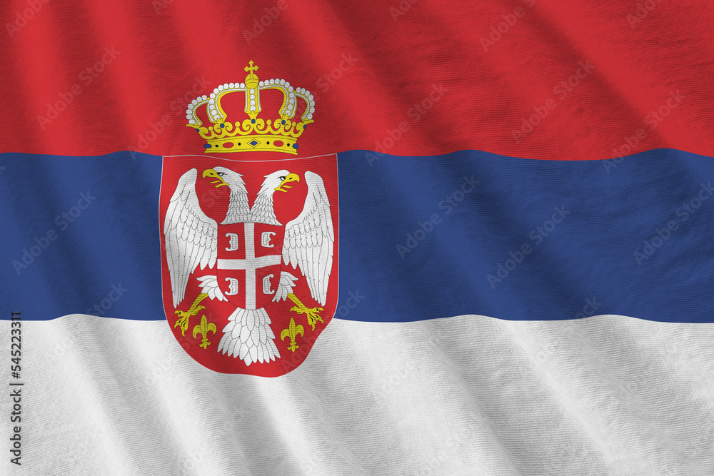 Serbia flag with big folds waving close up under the studio light ...