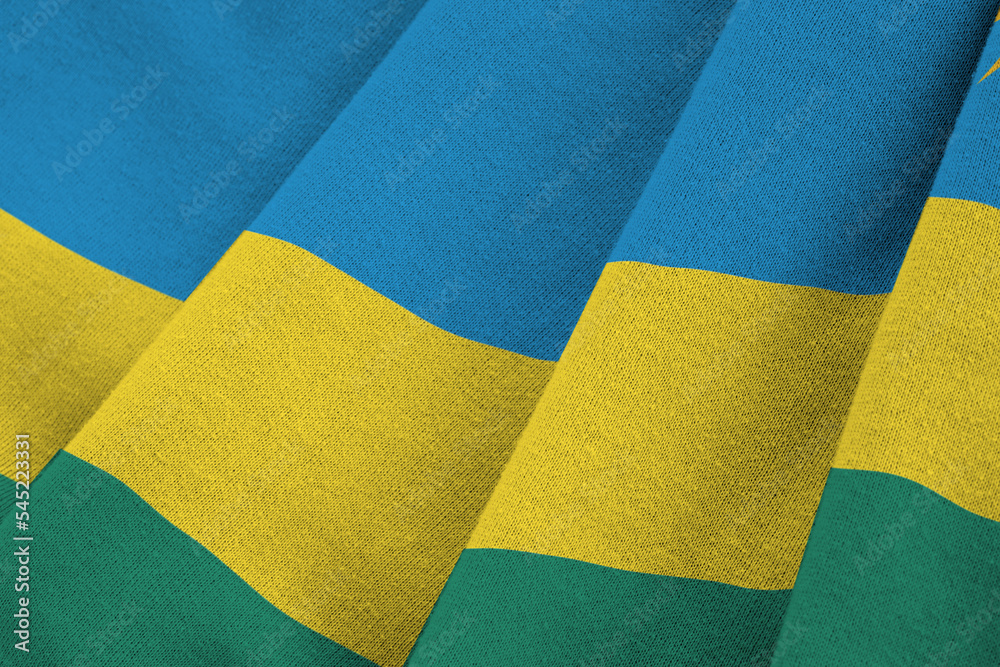Rwanda flag with big folds waving close up under the studio light ...