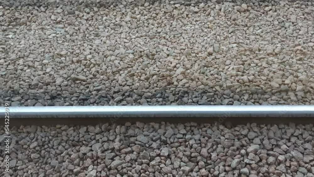 Tram rails on brownish gray stones. On dry granite stones scattered ...