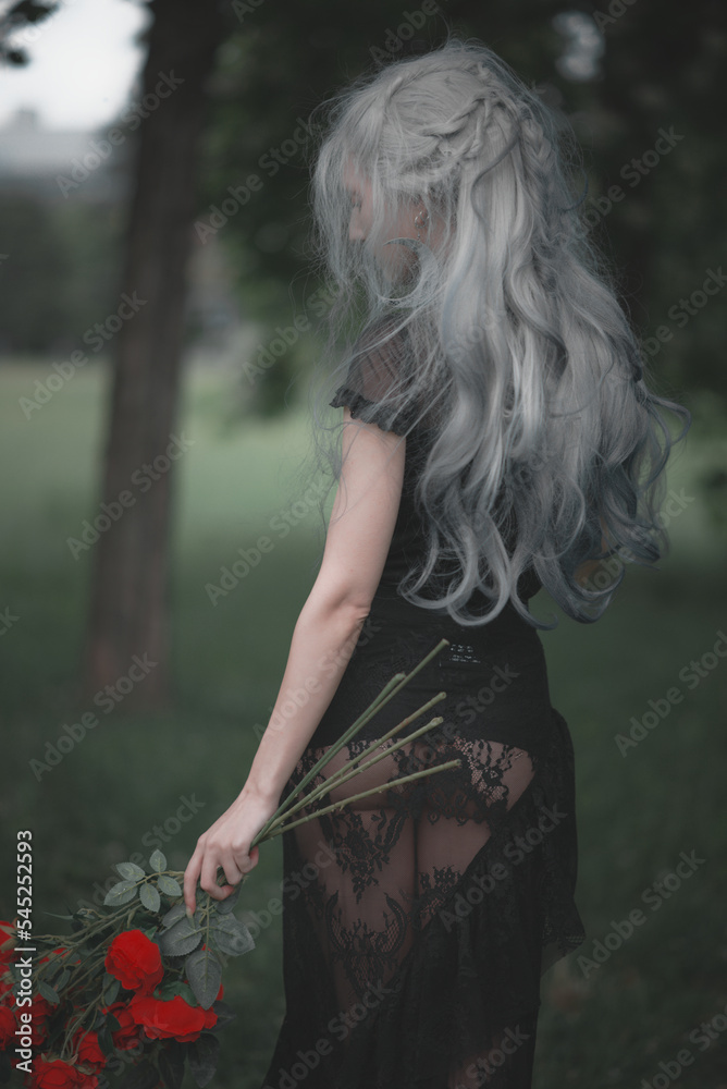 Dark goth girl standing in the forest, portrait of a wiccan witch ...