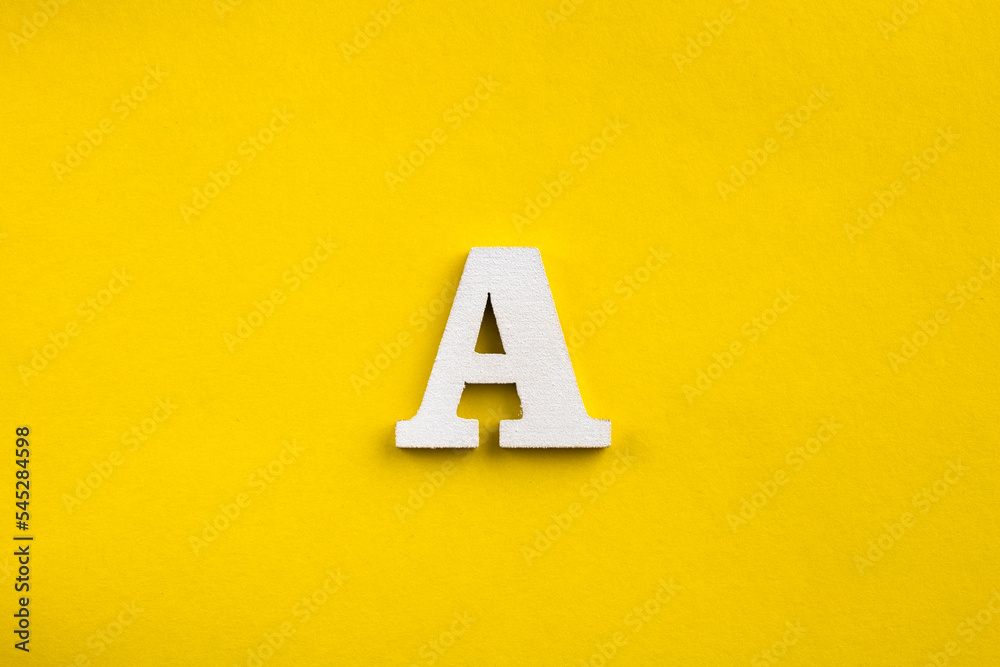Alphabet letter A - White wood letter on yellow colored background ...