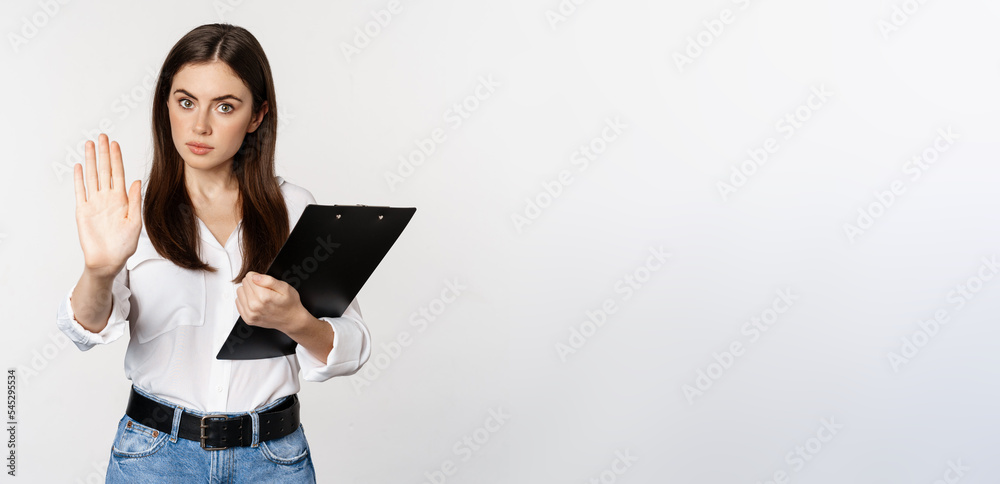 Serious woman with clipboard documents, extending arm, showing taboo ...