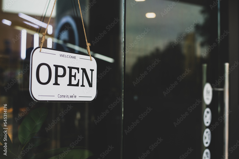 Open and closed flip sign in front of coffee shop and restaurant ...