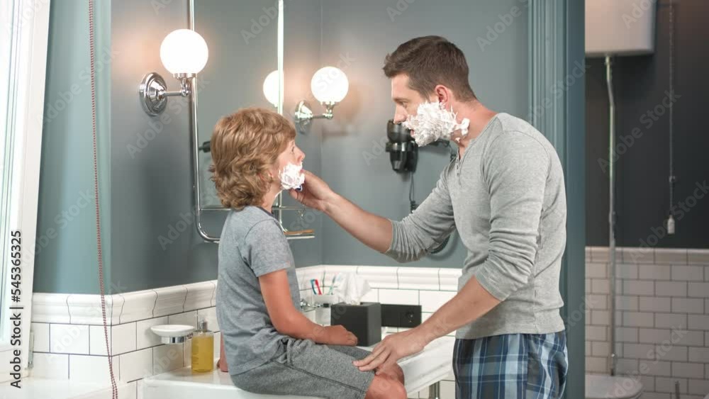 Close up of little teen boy sitting on sink indoor in bathroom ...