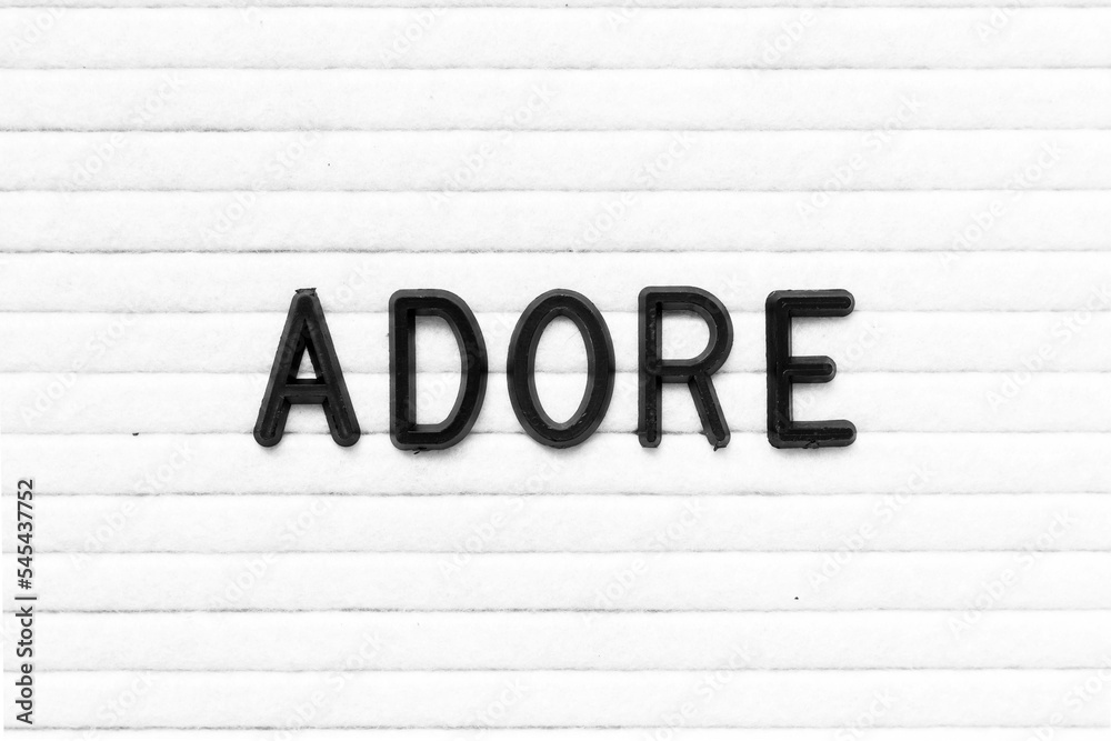 Black color letter in word adore on white felt board background Stock ...