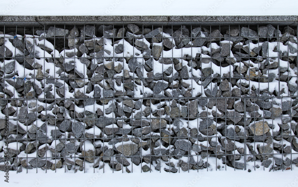 Gabion, texture, background. Snow covered gabion net and stone fencing ...