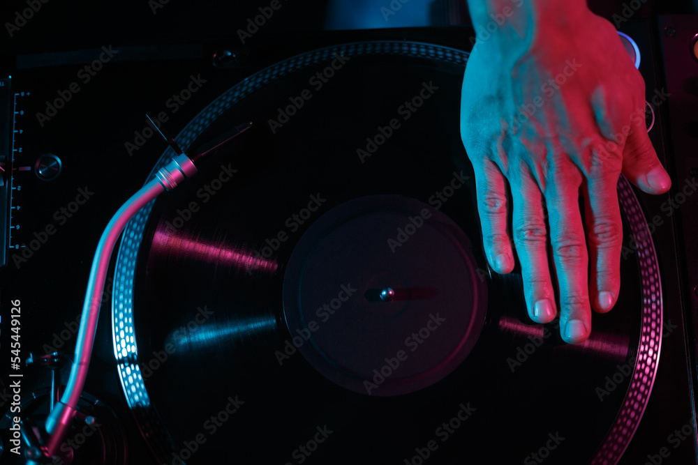 Hip hop dj scratching vinyl record on party in night club. Overhead ... Hip hop dj scratching vinyl record on party in night club. Overhead ...