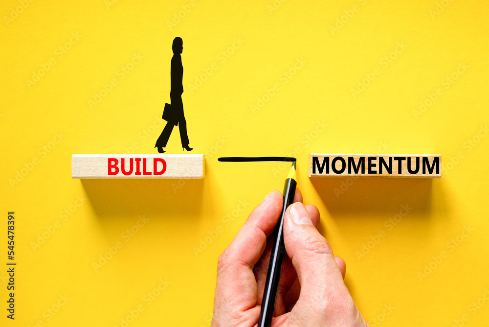 Build momentum symbol. Concept words Build momentum on wooden blocks ...