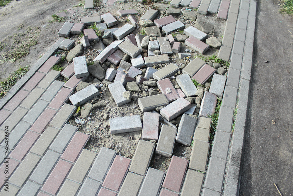 Damaged sidewalk. Broken pavement tiles. There is no passage. A hole in ...