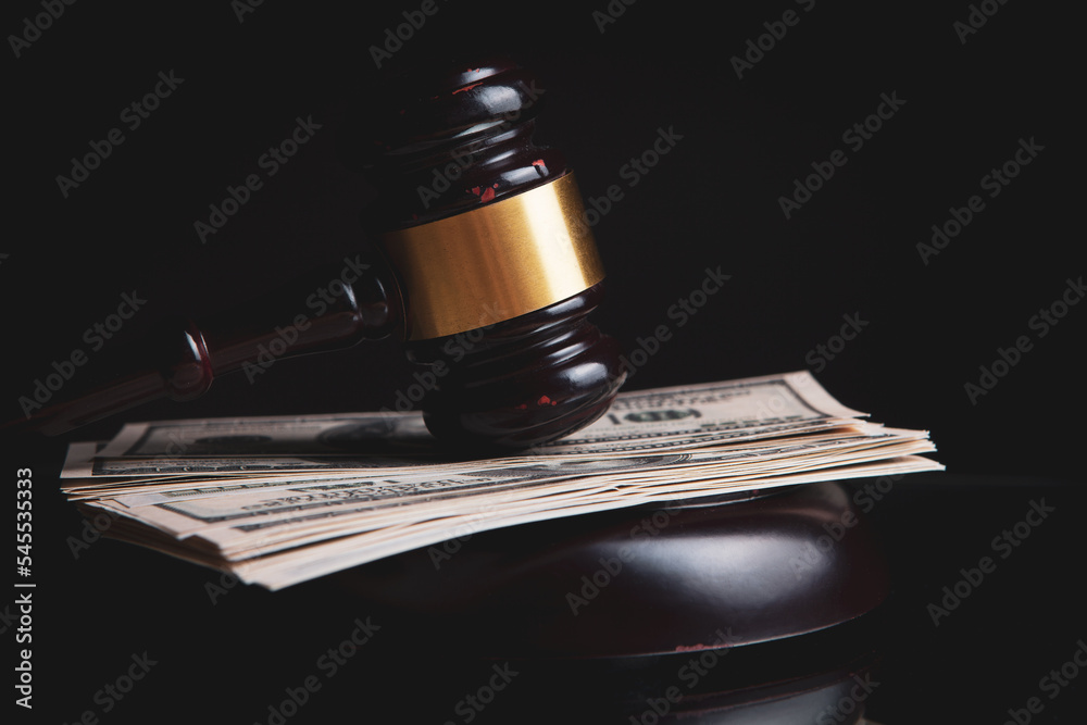 Hammer and money in court. Stock Photo | Adobe Stock