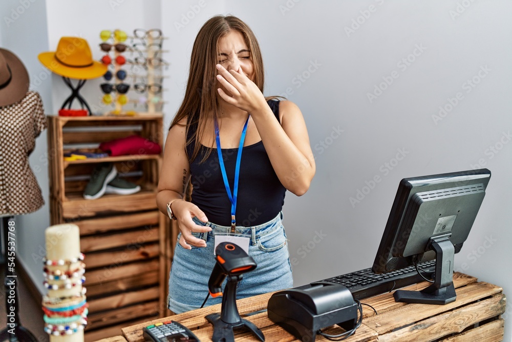 Young brunette woman holding banner with open text at retail shop ...