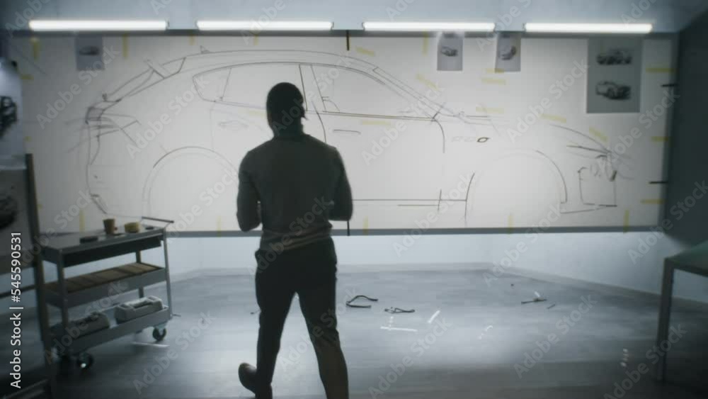 Back view of automotive african american male designer drawing sketch ...