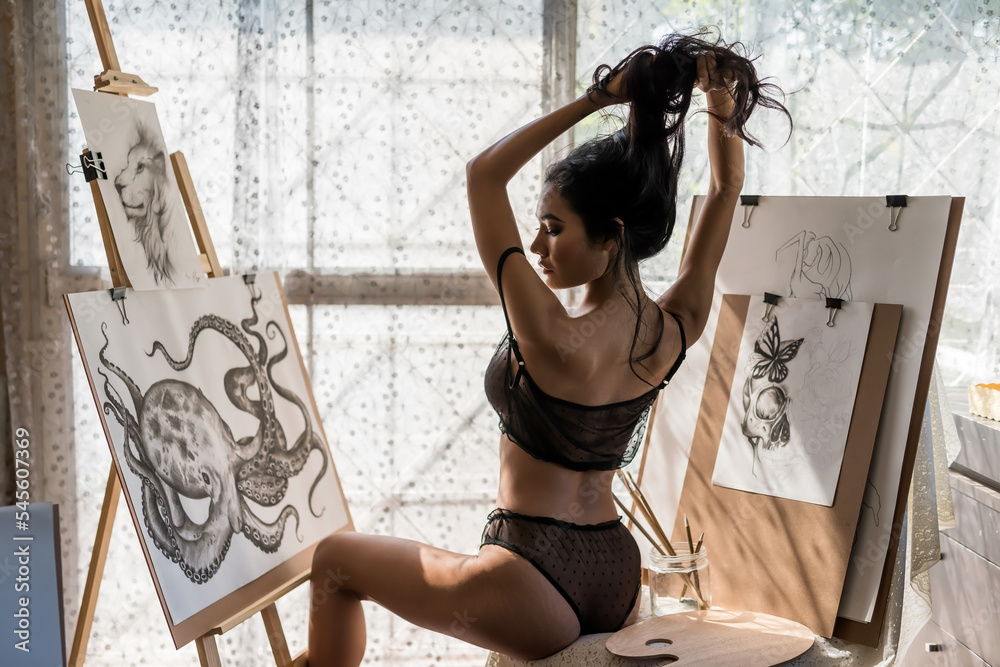 Sexy artist woman tie hair after paint octopus in art gallery Stock Photo | Adobe Stock