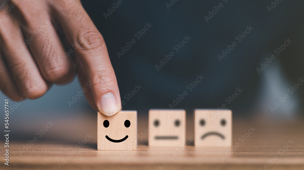 Close up customer hand choose smile face and blurred sad face icon on ...