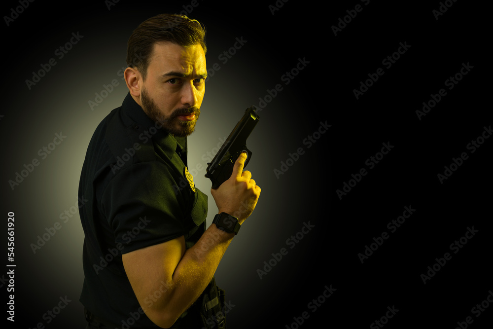 Handsome police agent holding his weapon while on duty Stock Photo ...
