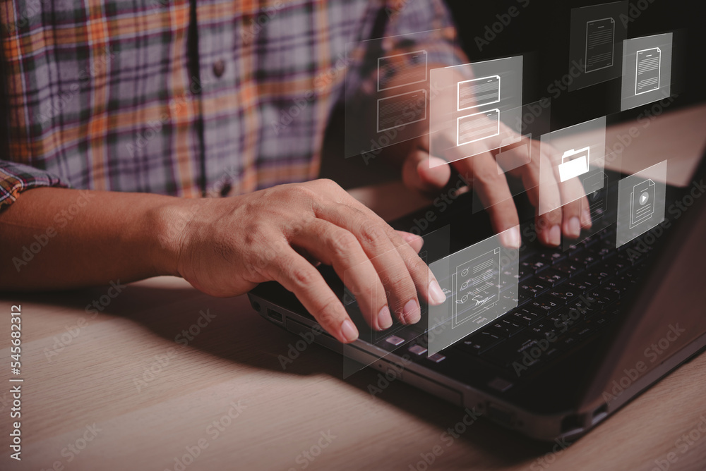 man using laptop access multiple files document on virtual screen ...