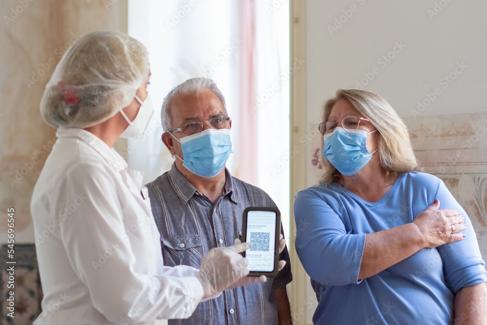 Helpful nurse explaining patients how use QR-code. Doctor in uniform ... Helpful nurse explaining patients how use QR-code. Doctor in uniform ...