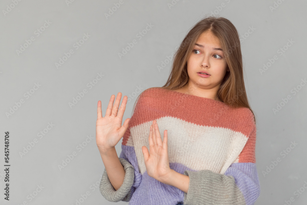 Teen girl making refuse gesture, emotional portrait grey background ...