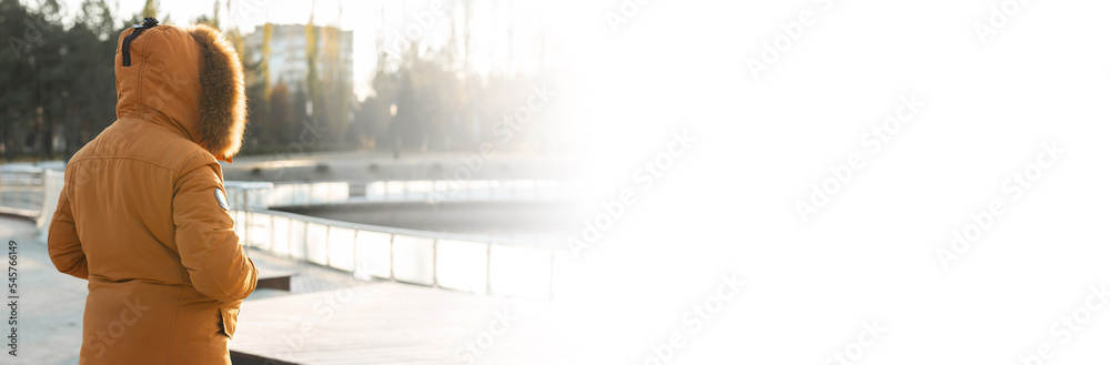 Banner winter is coming, Man wearing winter jacket back view on cold ...