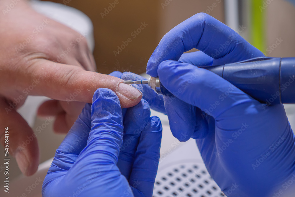 Manicurist master removing cuticles. Processing of rough cuticles and ...