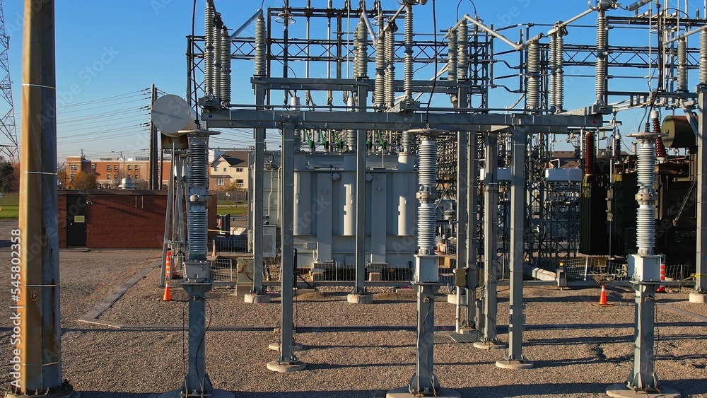 High voltage power grid station. Pylons and high voltage transferring ...