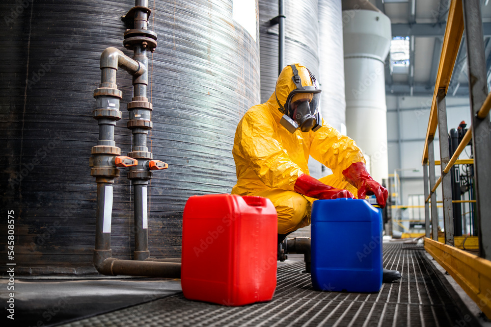 Working in chemicals production factory. Professional worker in ...