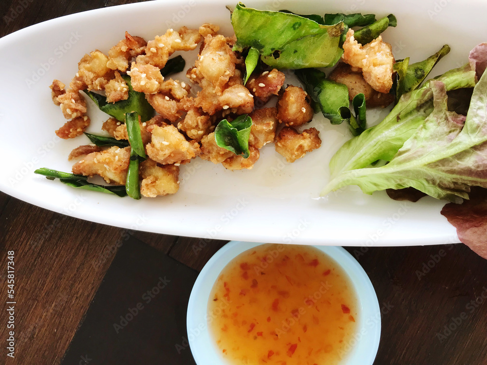 Picture of crispy breaded chicken tendons beautifully placed on dining ...